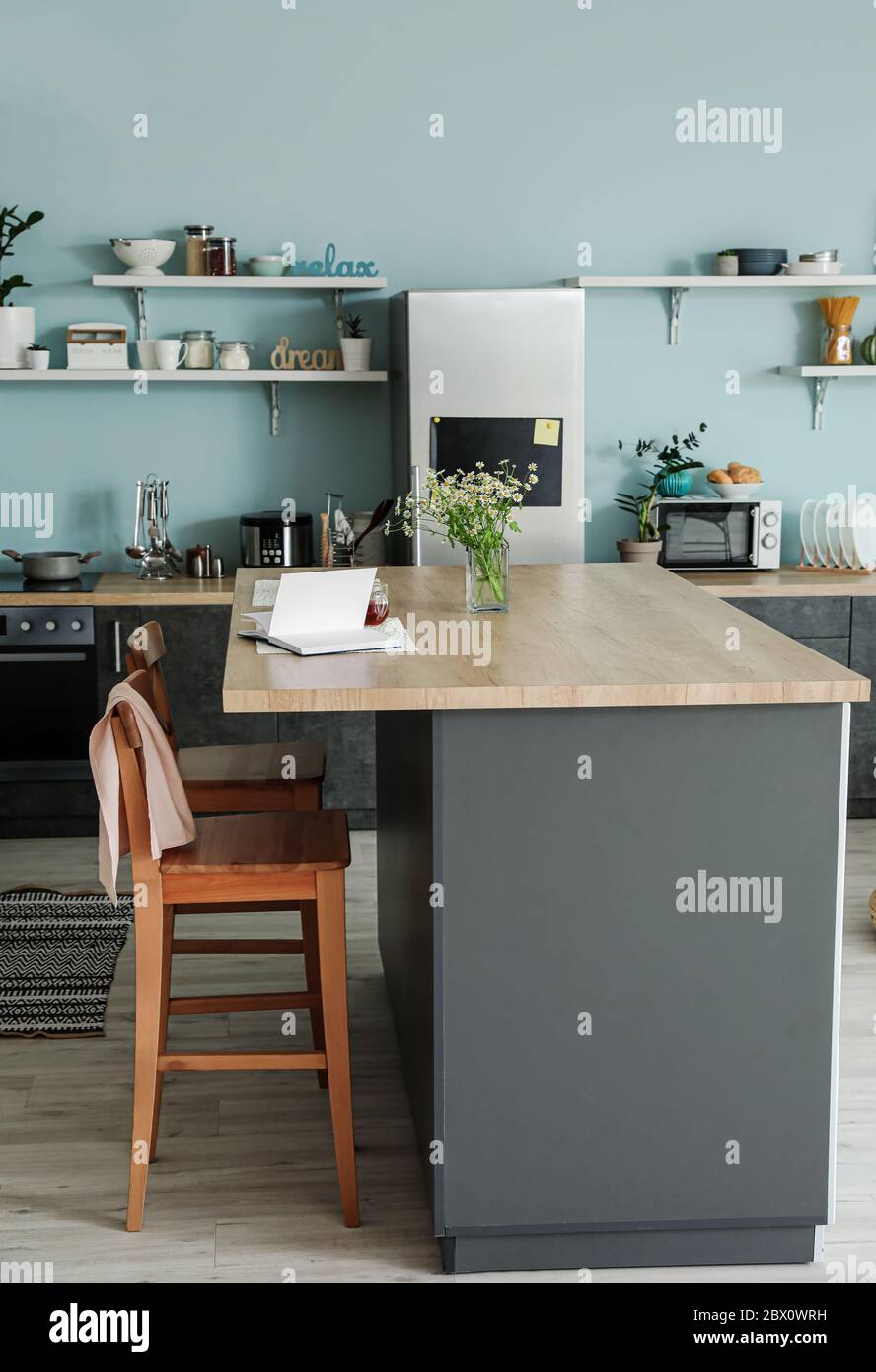 Interior of modern kitchen with stylish table Stock Photo - Alamy