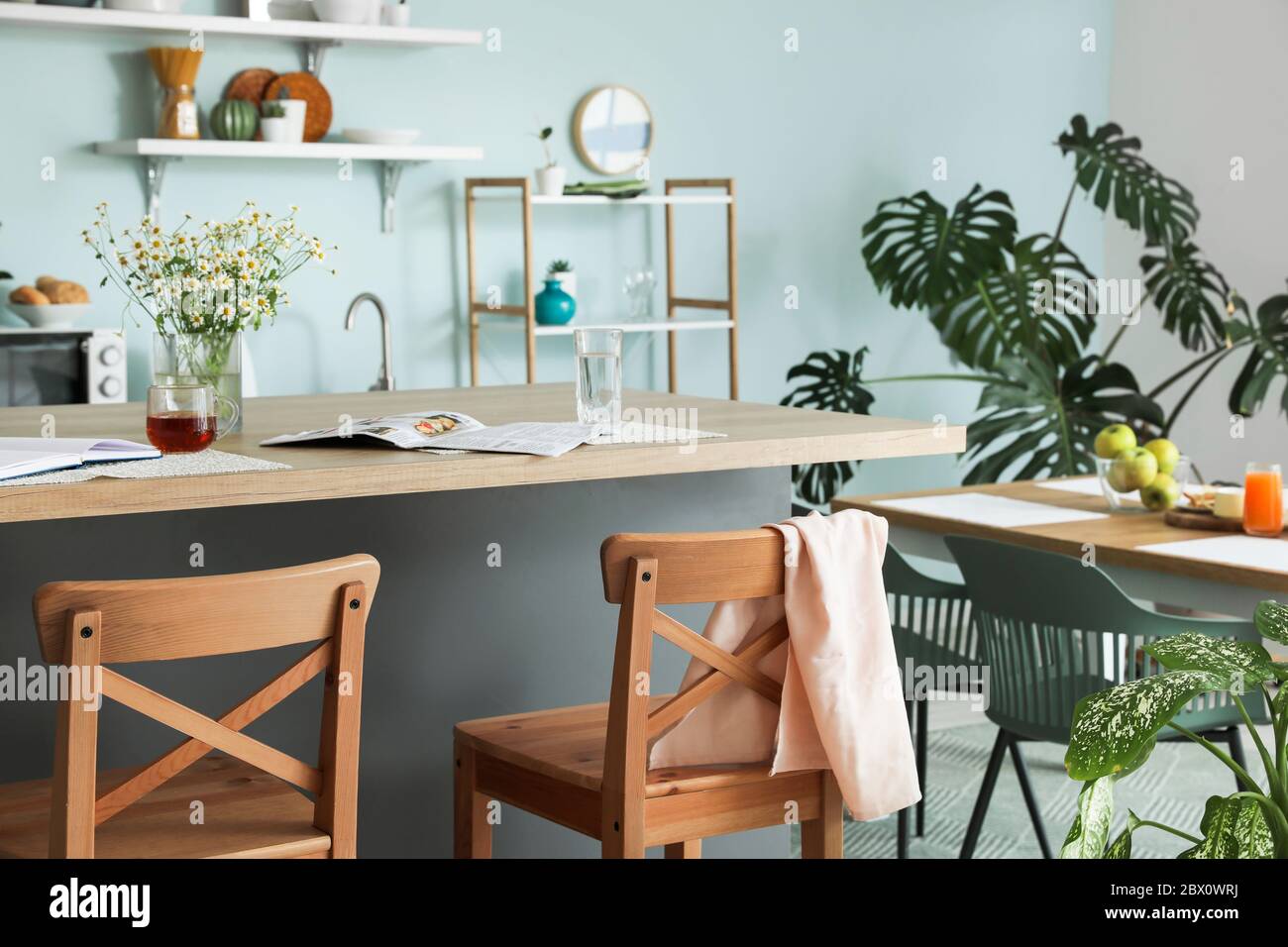 Interior of modern kitchen with stylish table Stock Photo - Alamy