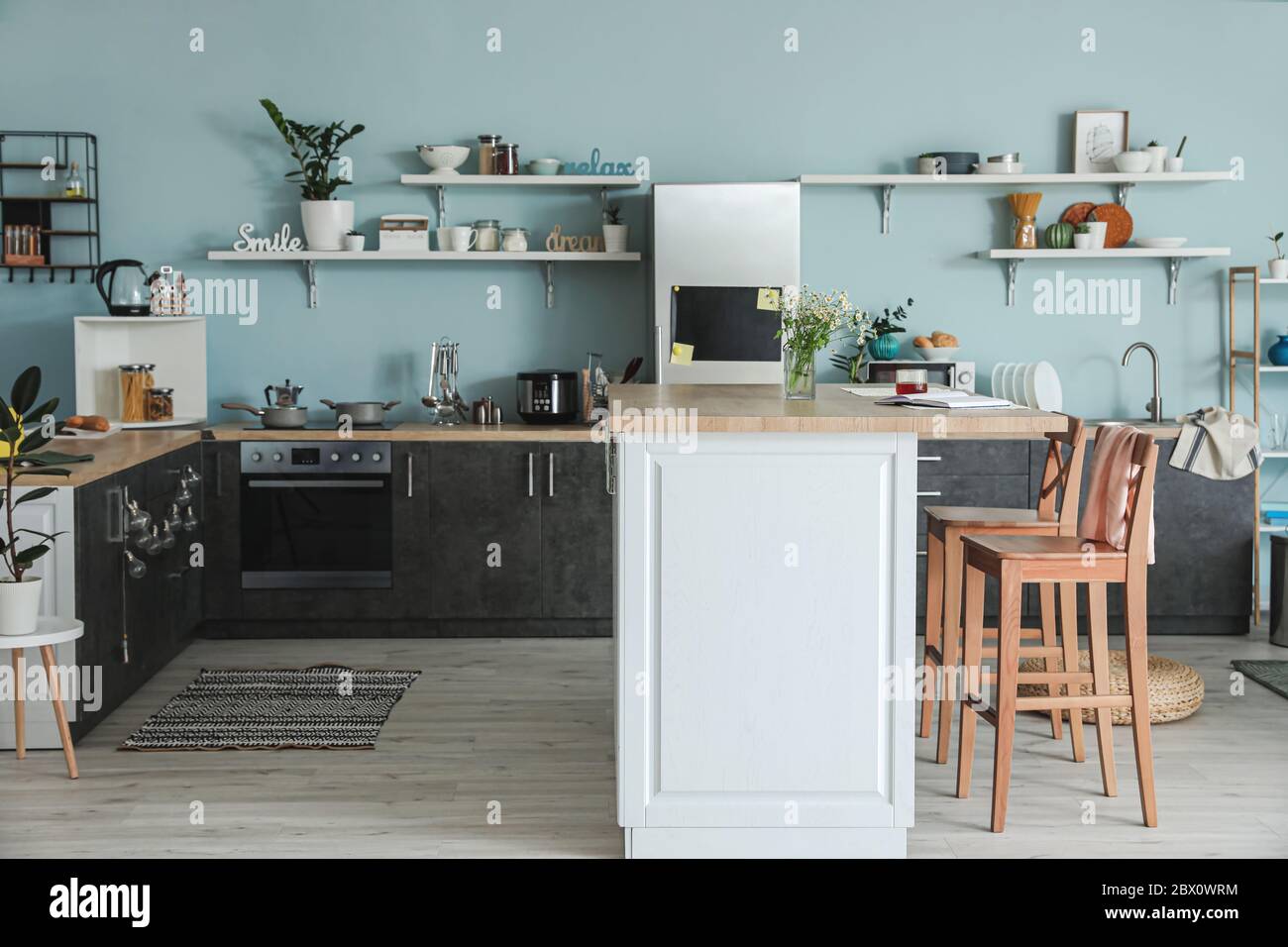 Interior of modern kitchen with stylish table Stock Photo - Alamy