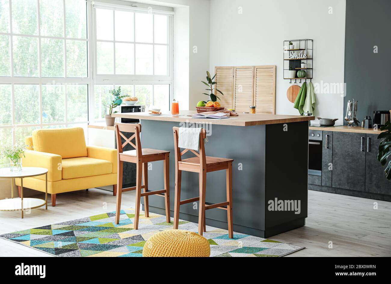 Interior of modern kitchen with stylish table Stock Photo - Alamy