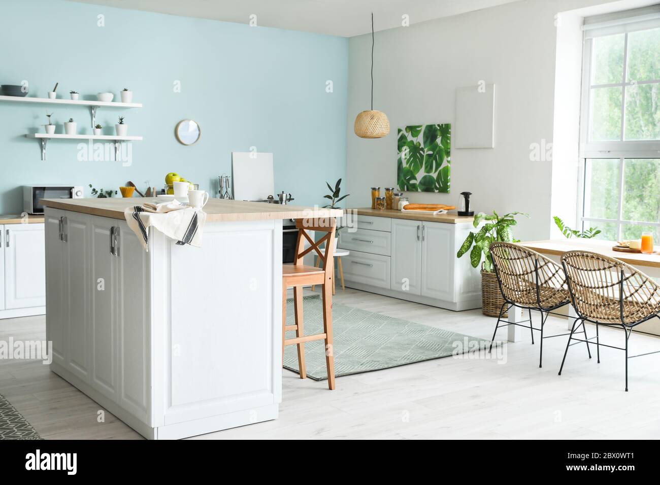 Interior of modern kitchen with stylish table Stock Photo - Alamy