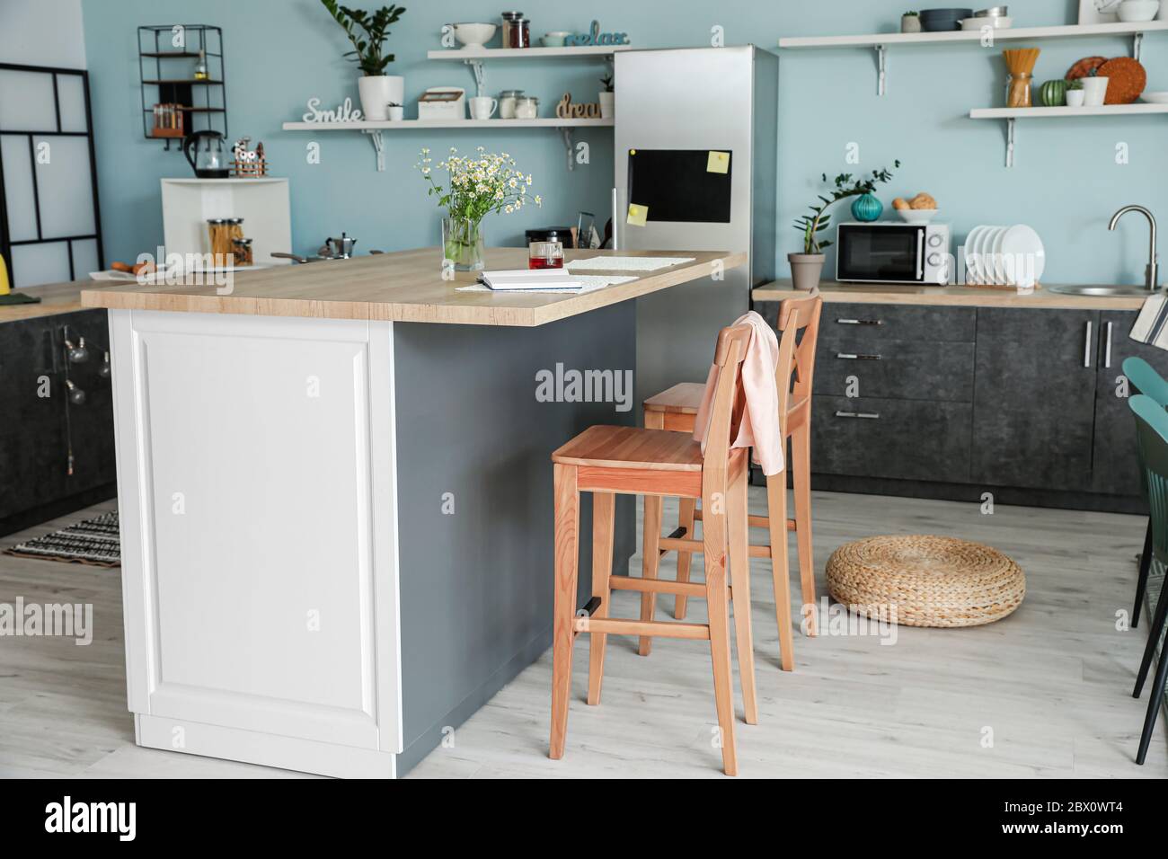 Interior of modern kitchen with stylish table Stock Photo - Alamy