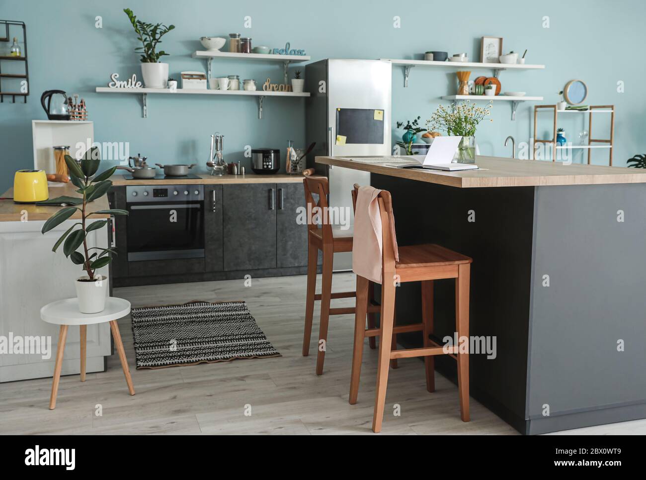 Interior of modern kitchen with stylish table Stock Photo - Alamy