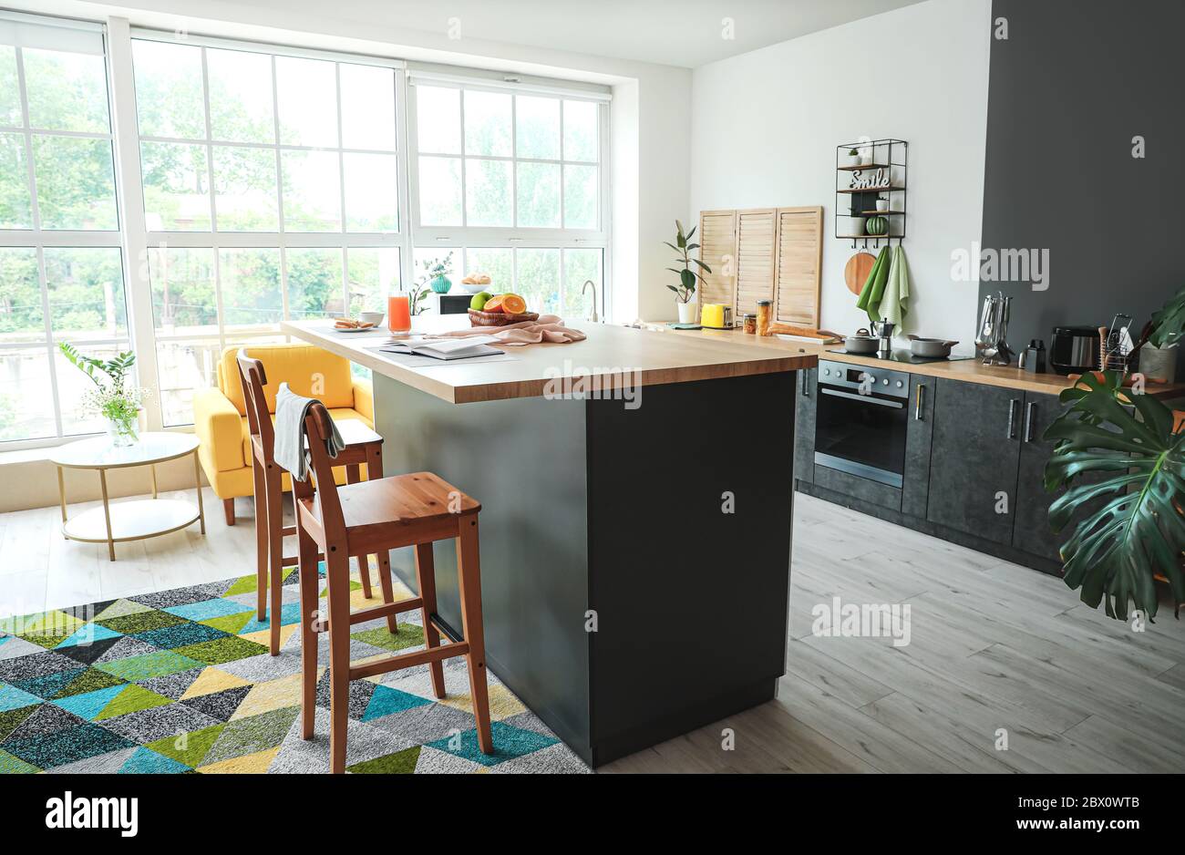 Interior of modern kitchen with stylish table Stock Photo - Alamy
