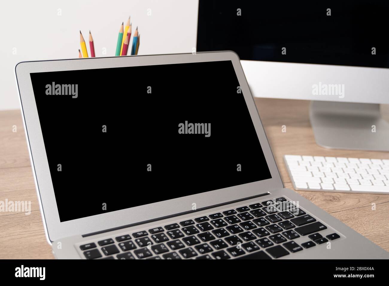 Laptop with blank screen on table. Workspace background new project on ...