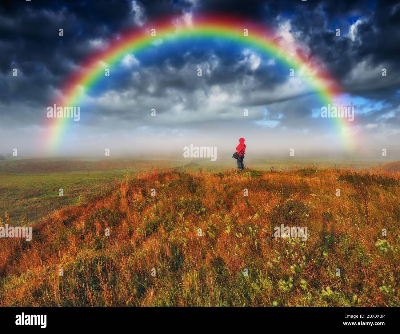 Woman Looking At Rainbow. At moment of wonderful Stock Photo - Alamy