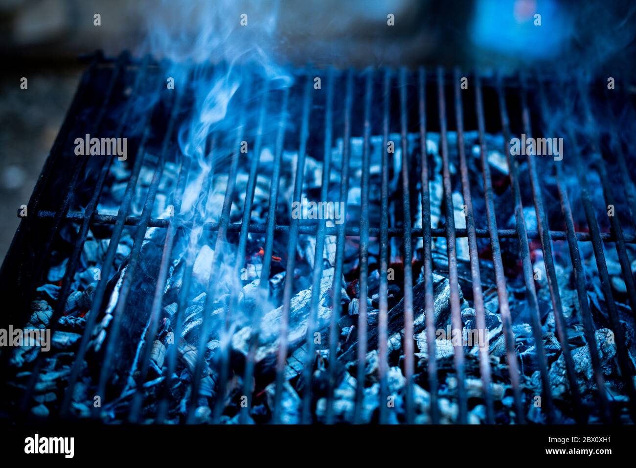 Empty flaming charcoal grill with open fire, ready for steak ...