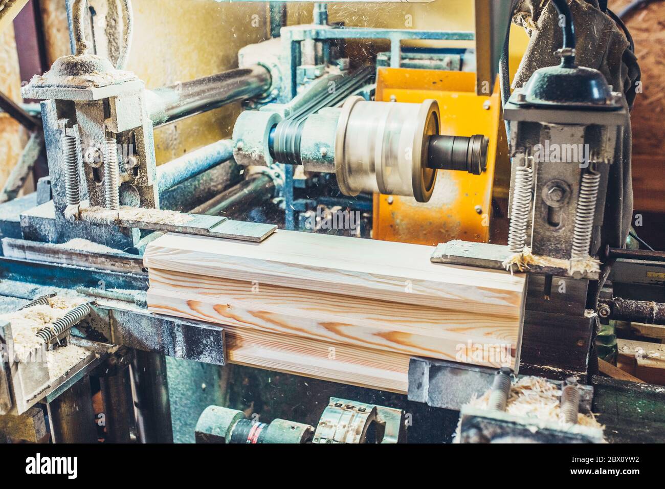 Cutting the lock and joints in the profiled bar to assemble a wooden ...
