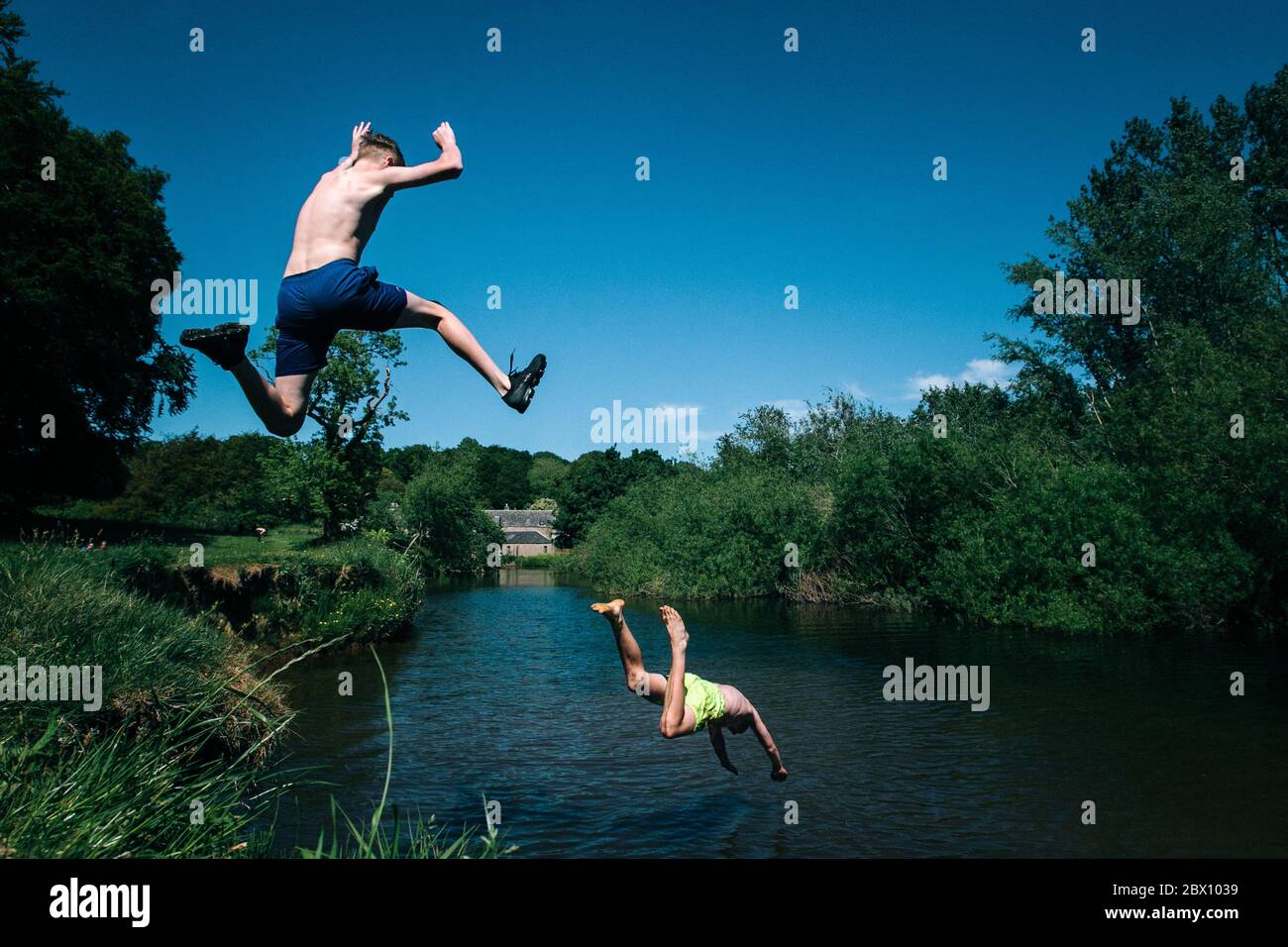 Teenagers jumping into water hi-res stock photography and images - Alamy