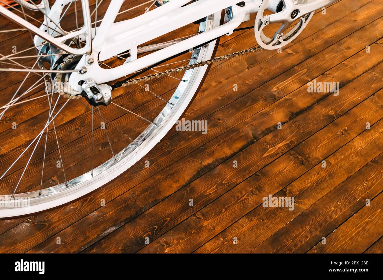 The wheel of a stylish bicycle with a white rim and a brown rubber tire ...