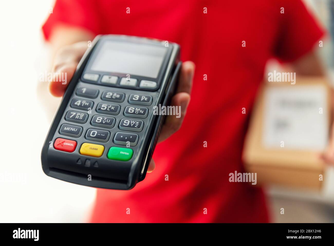 delivery man with parcel and pos terminal for payment Stock Photo - Alamy