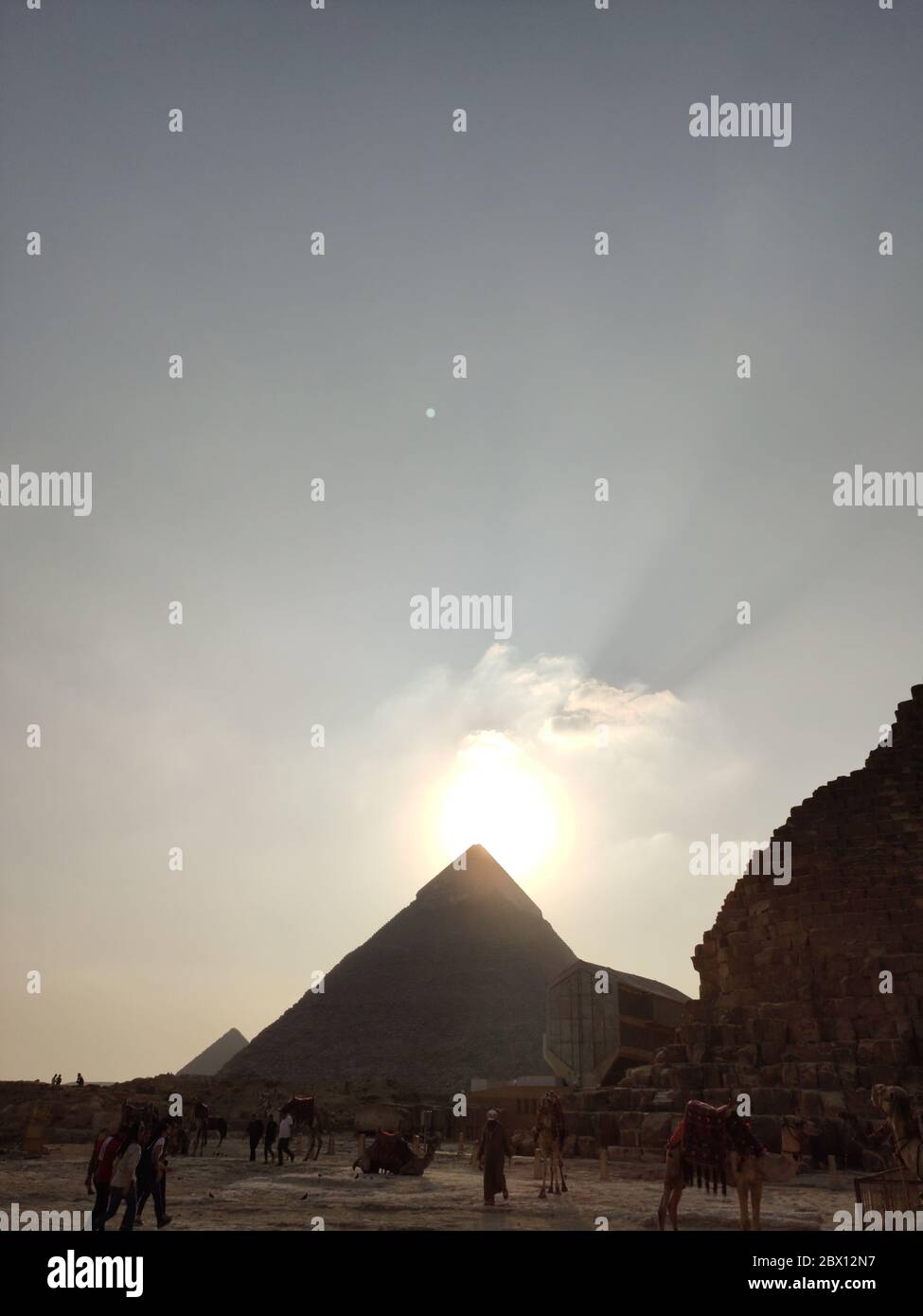 sunset on the background of Egyptian pyramids Stock Photo - Alamy