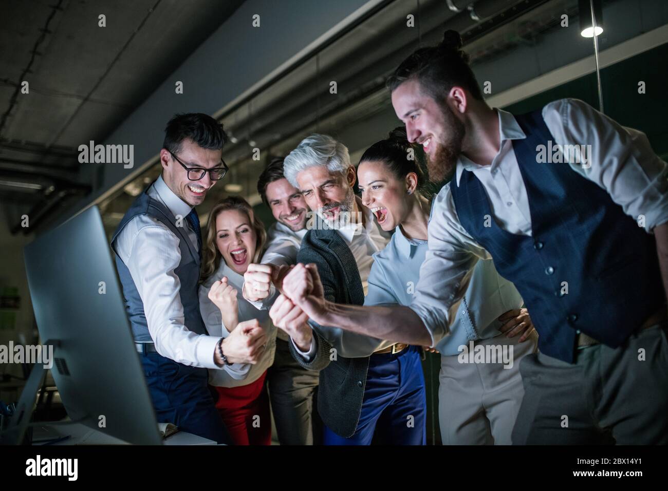 A group of business people with computer in an office, expressing ...