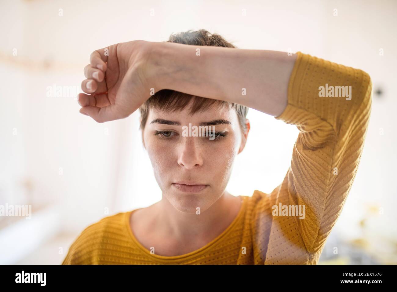 Front view of sad young woman standing indoors at home, close-up Stock ...
