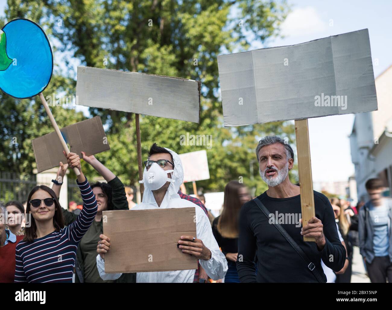 People with placards and protective suit on global strike for climate ...