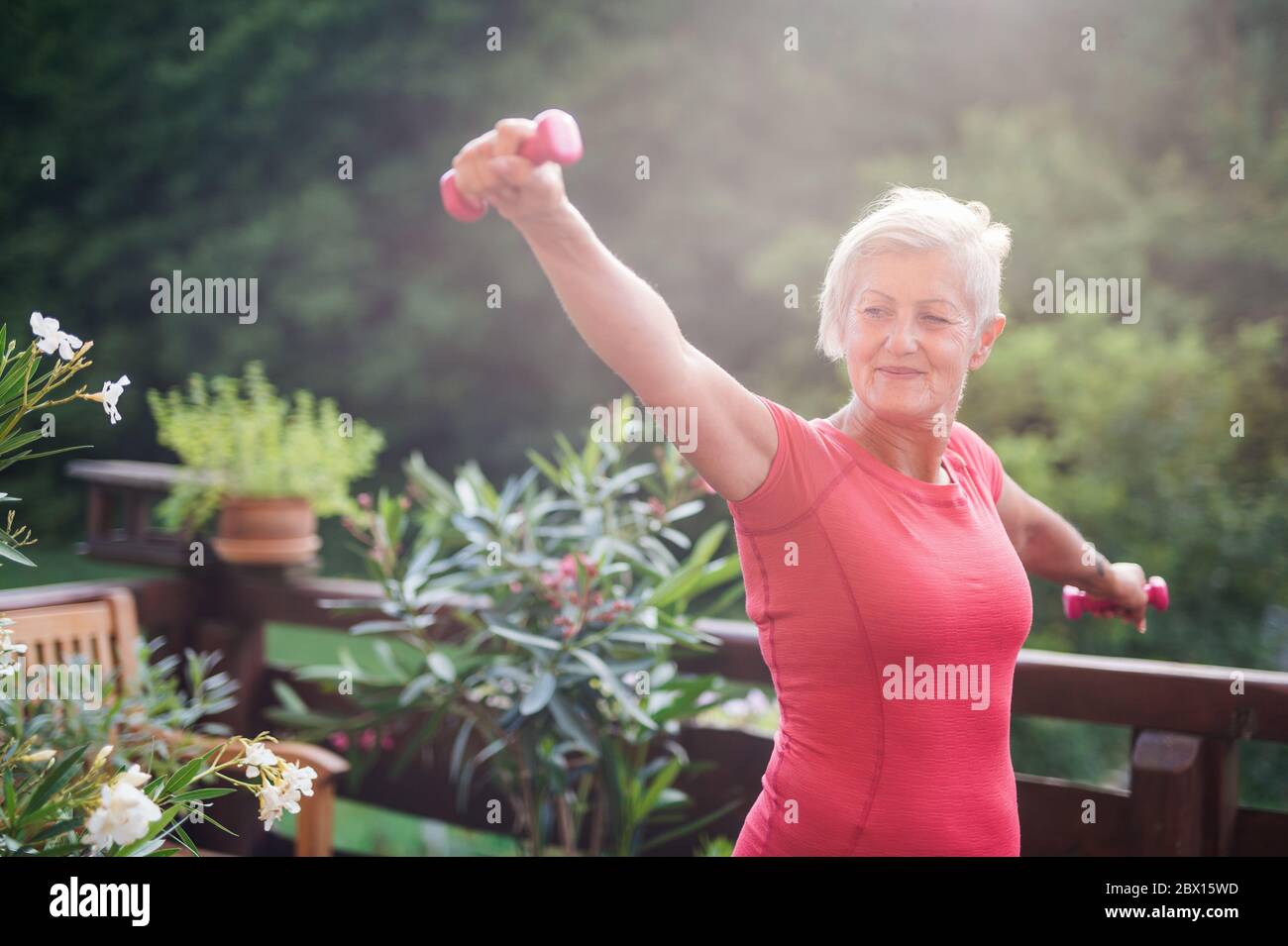 Elderly woman doing exercise hi-res stock photography and images - Alamy