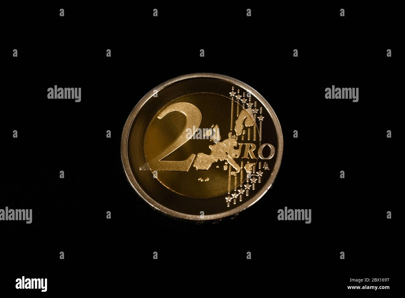 Two Euro coin isolated on a deep black background Stock Photo - Alamy