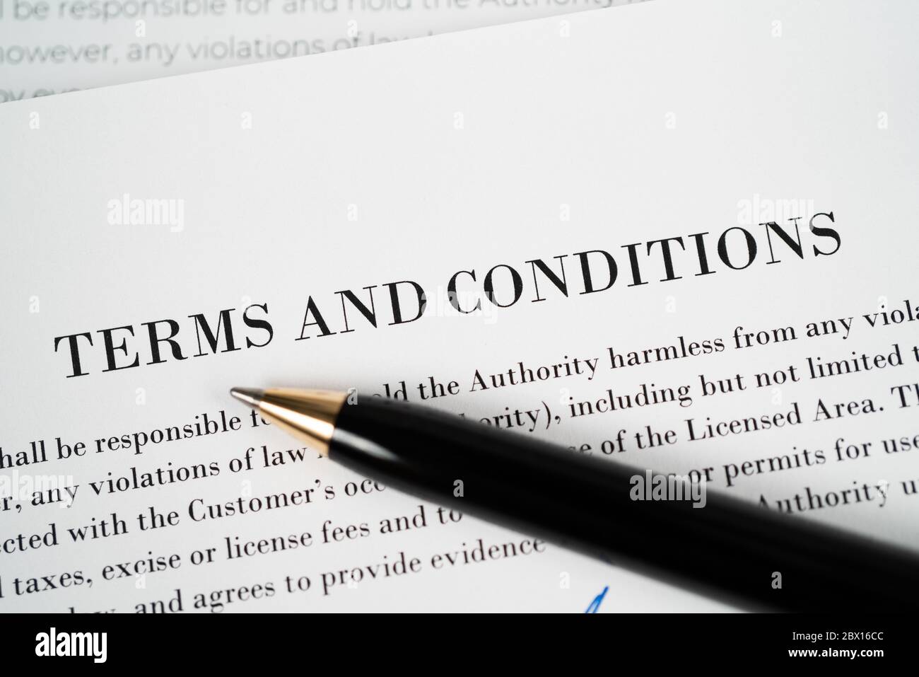 Pen on the signature line on a terms and conditions agreement ready to ...