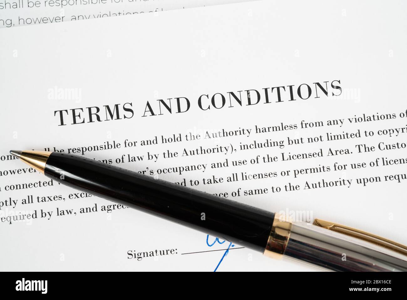 Pen on the signature line on a terms and conditions agreement ready to ...