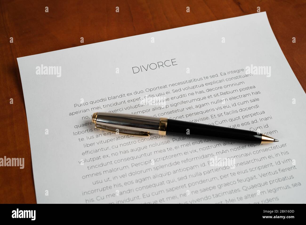Divorce with a pen ready to be signed on a wooden desk Stock Photo - Alamy