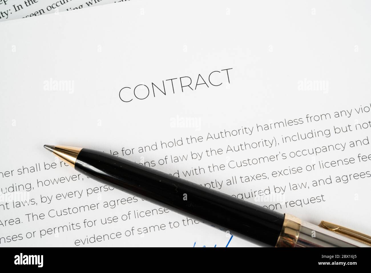 Pen on top of a contract just been signed Stock Photo - Alamy