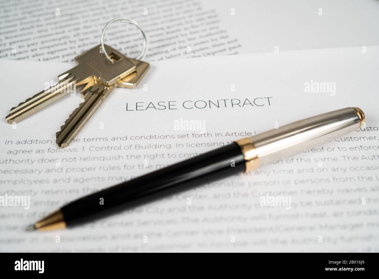 Close up of Lease contract with house keys and pen ready to be signed ...