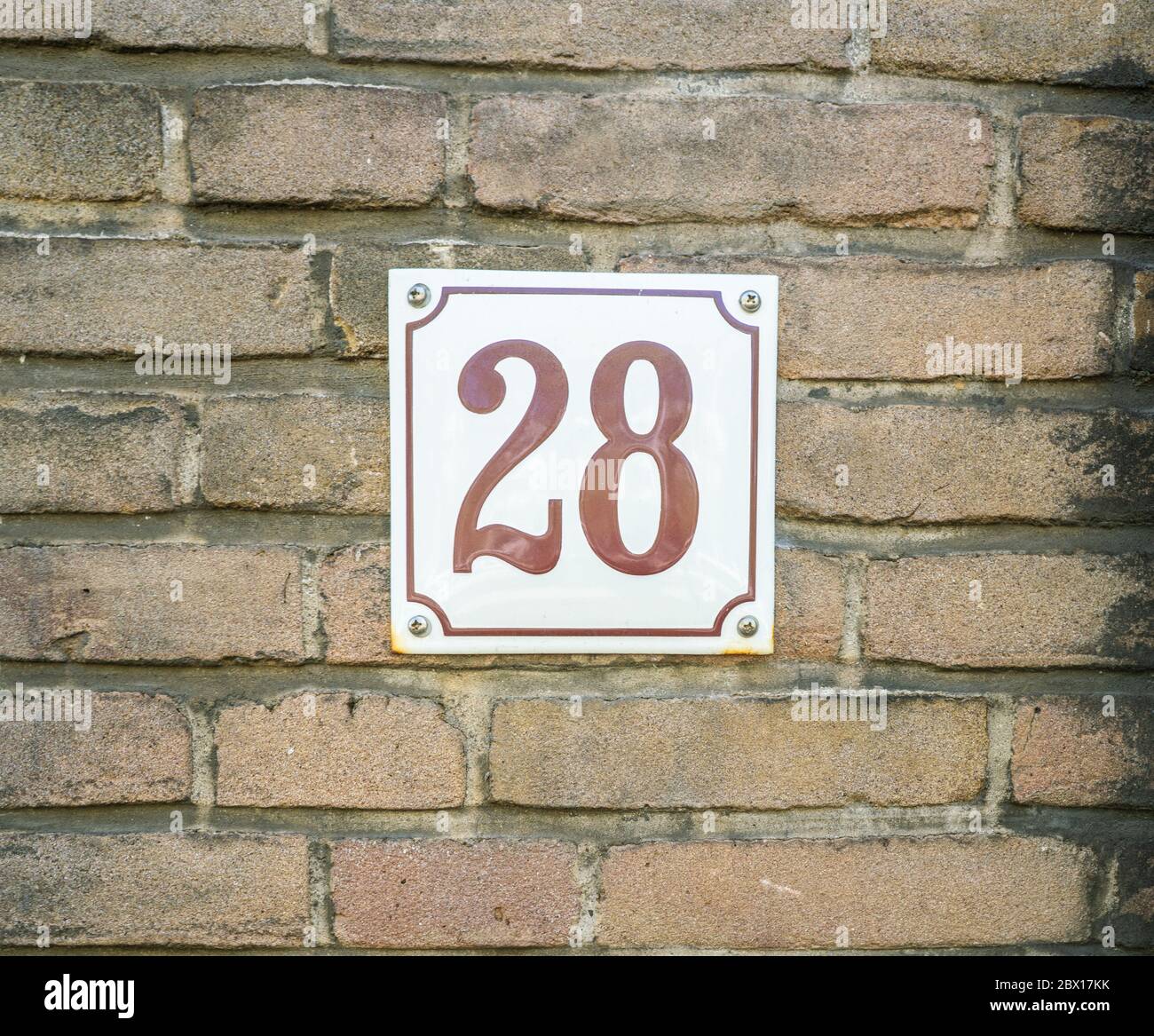 House Number 28 twenty eight. brown numbers on a white plate ...
