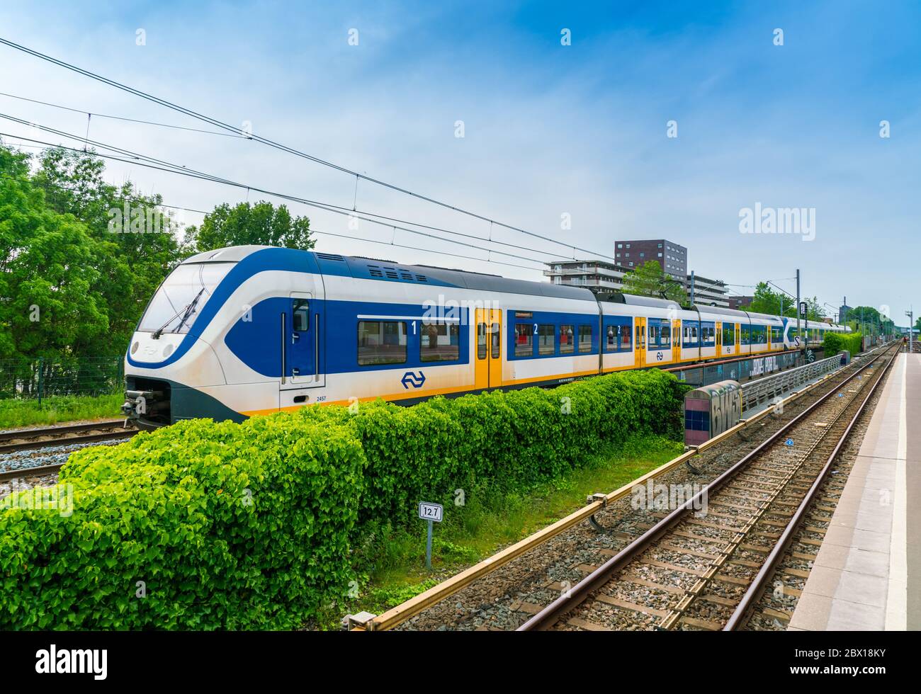Amsterdam, The Netherlands, May 22 2017: Dutch Train passing small ...