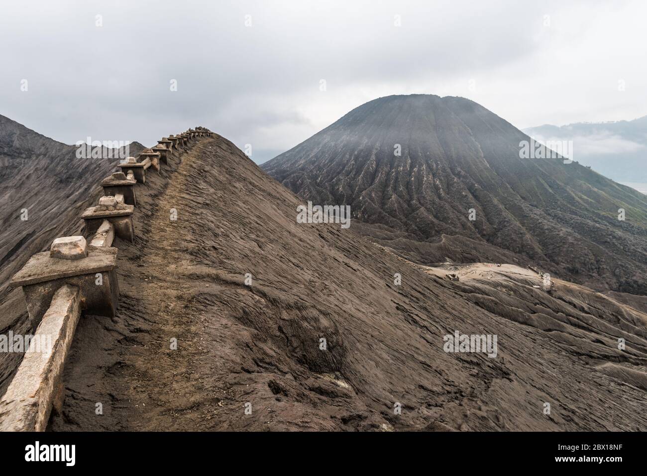 view of Mount Bromo under cloudy sky with the sand sea Stock Photo - Alamy