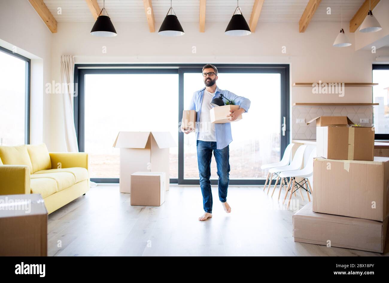 Man walking with boxes hi-res stock photography and images - Alamy