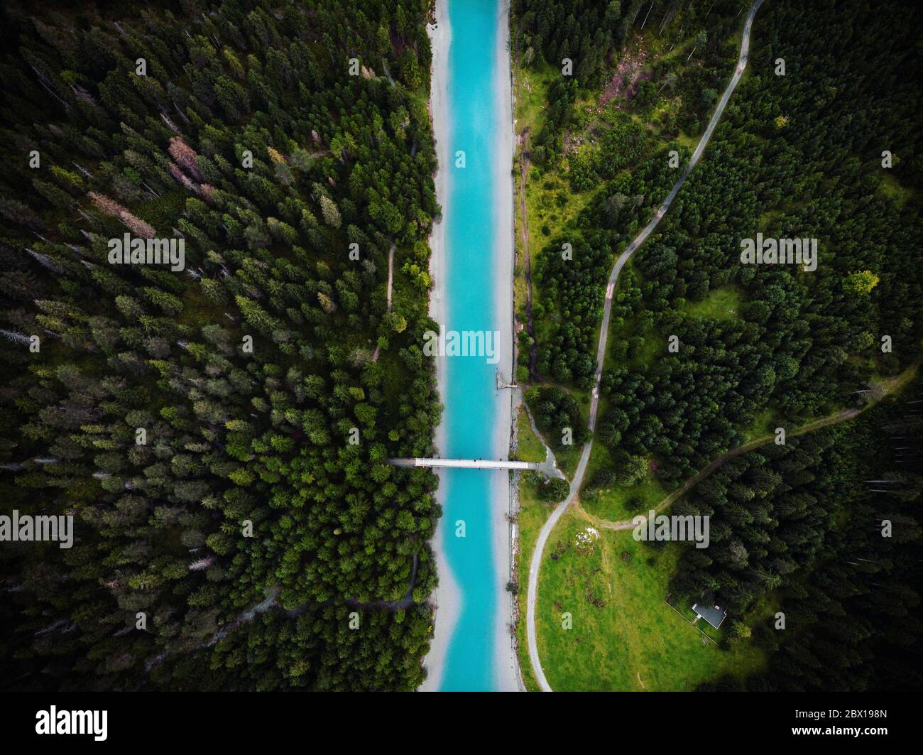 Aerial view of blue canal surrounded by green forest Plansee Tyrol ...