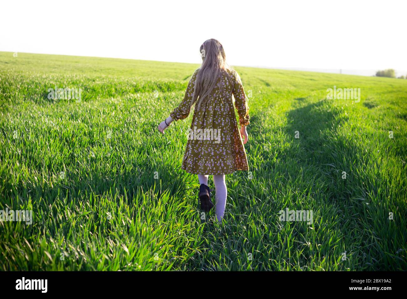 happy girl is joyful walk in the green field. summer and freedom Stock ...