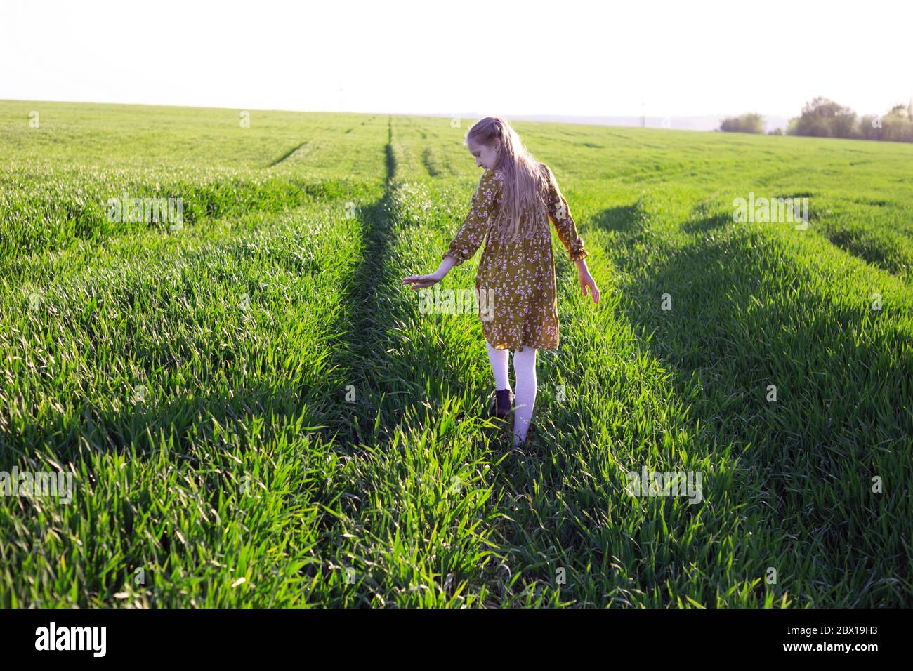 happy girl is joyful walk in the green field. summer and freedom Stock ...