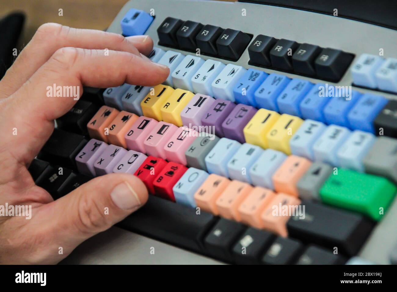 Close up of video editor working with dedicated keyboard for video ...