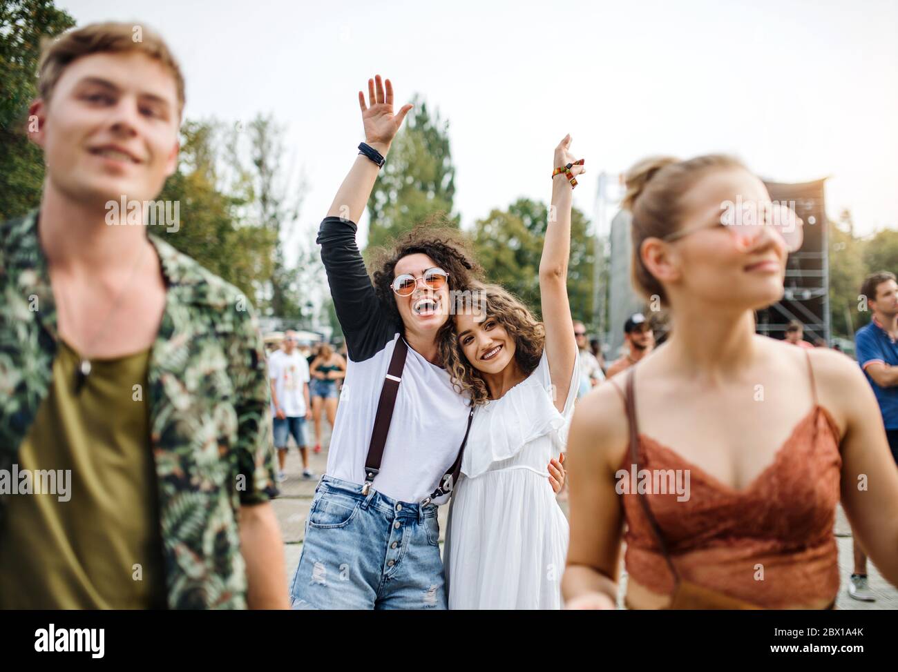 Front view portrait of group of young friends dancing at summer ...