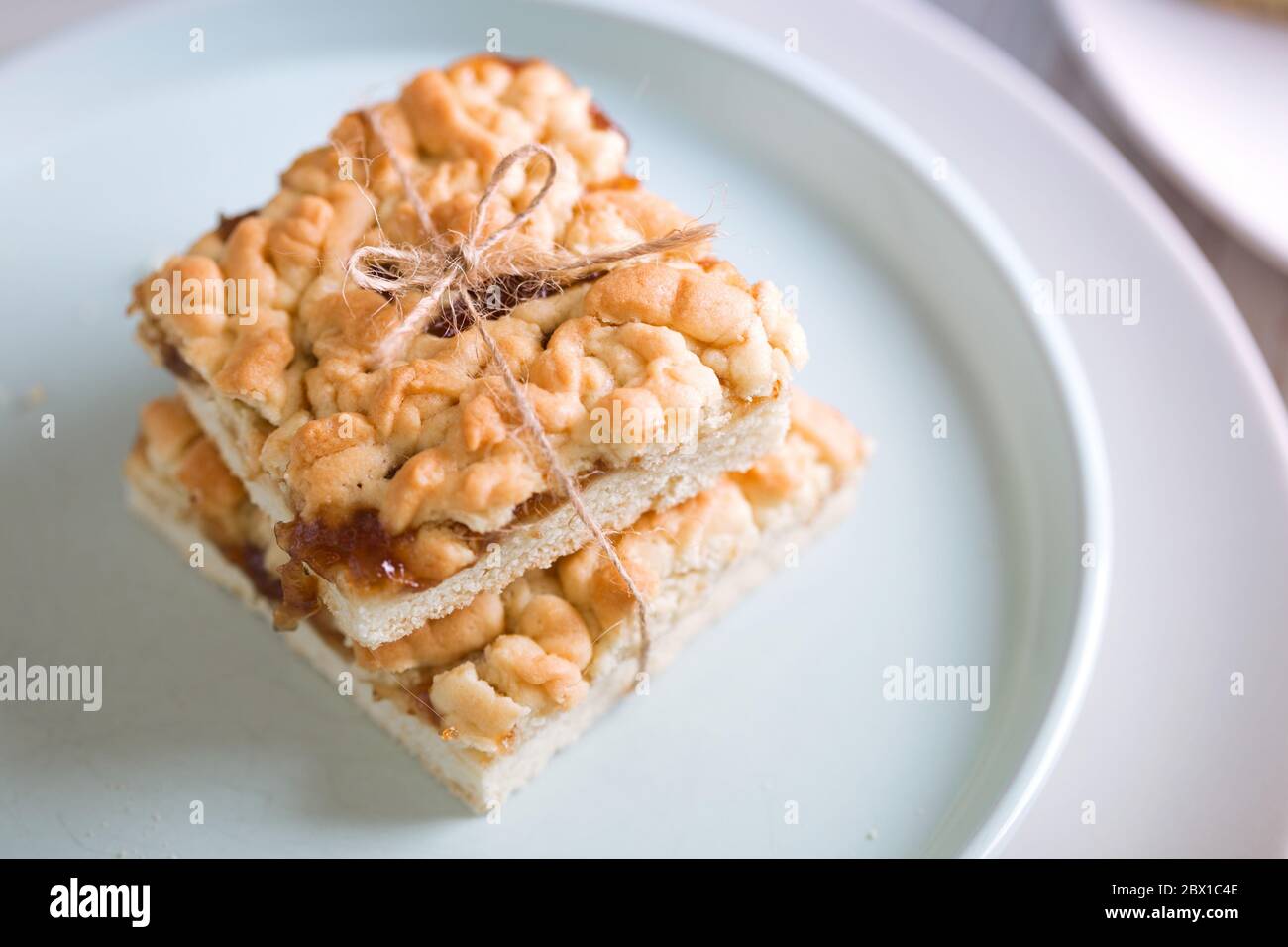 Grated Cake With Jam on a white wooden background Stock Photo - Alamy