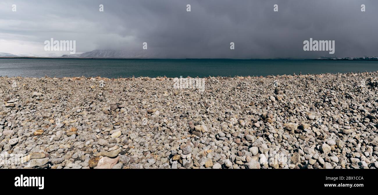 Stone pebbles on the beach in Reykjavik, Iceland. Panoramic views of ...