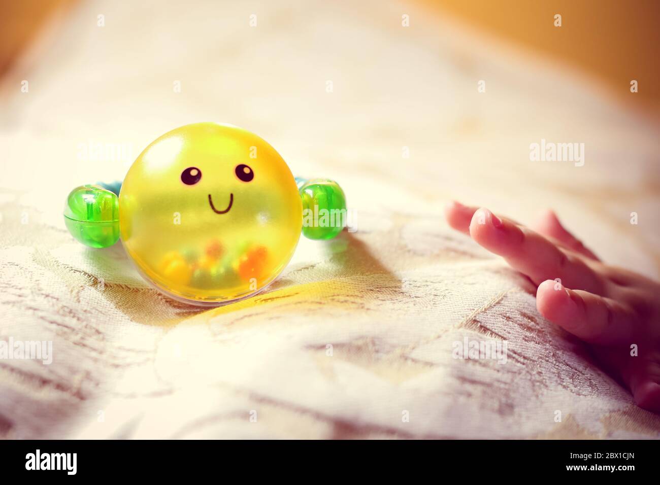 infant baby playing with toy - rattle toys Stock Photo - Alamy