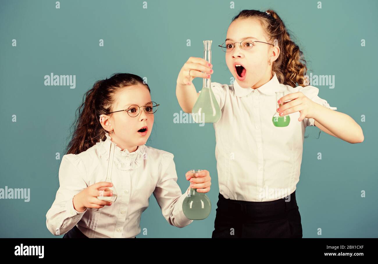 little smart girls with testing flask. back to school. school kid ...