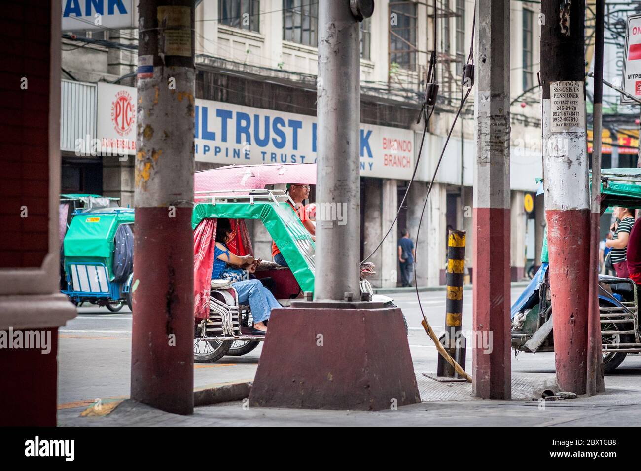 All manner of traffic and pedestrians pass under the Filipino Chinese ...