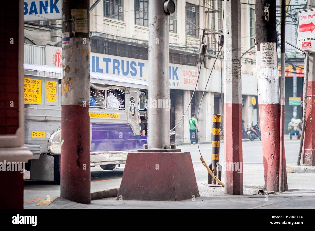 All manner of traffic and pedestrians pass under the Filipino Chinese ...