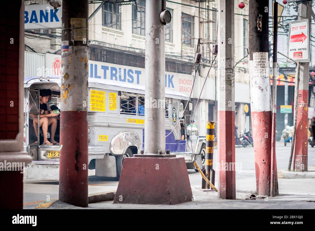 All manner of traffic and pedestrians pass under the Filipino Chinese ...