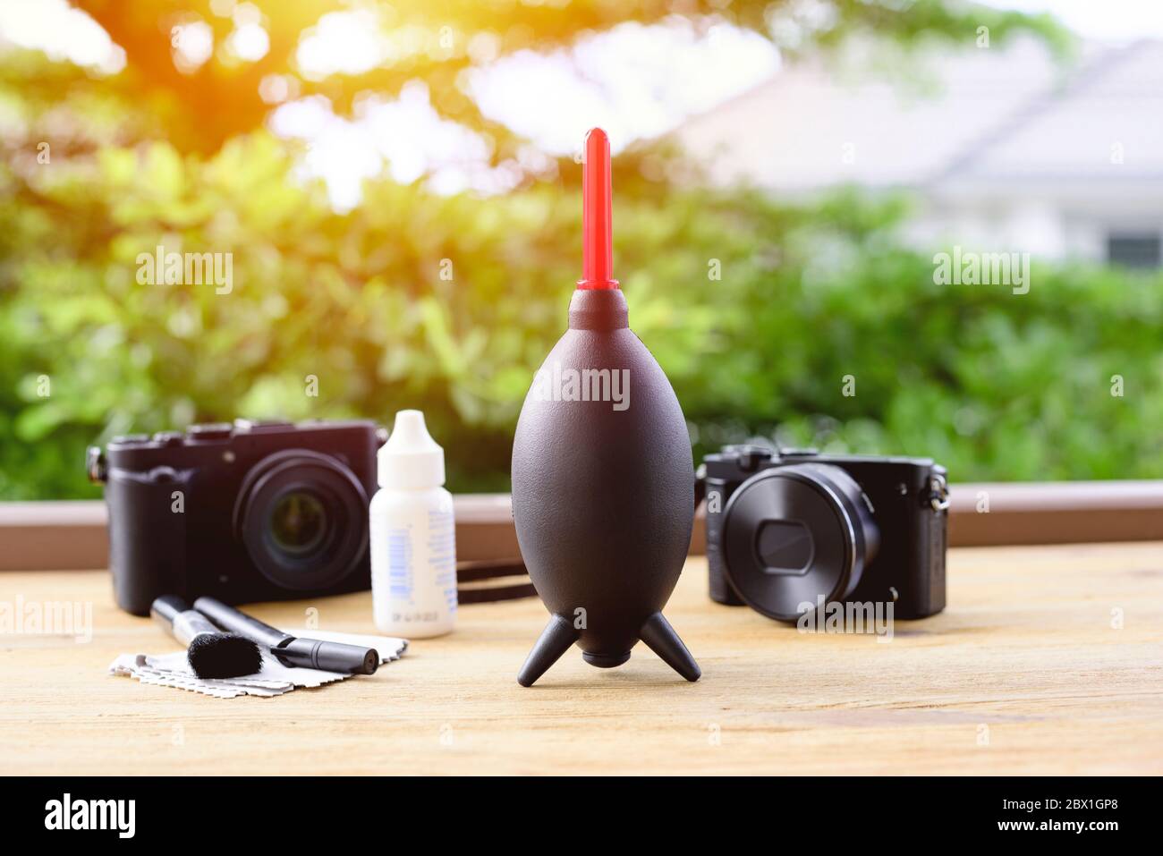 Camera and lens care. Camera cleaning kits and camera gears on wooden ...