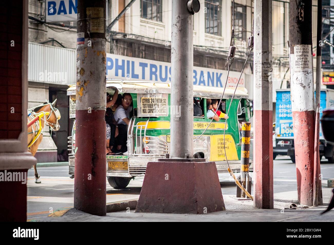 All manner of traffic and pedestrians pass under the Filipino Chinese ...