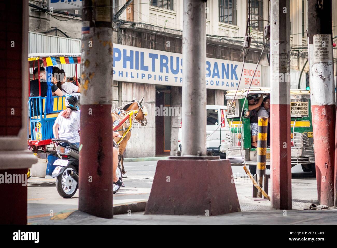 All manner of traffic and pedestrians pass under the Filipino Chinese ...