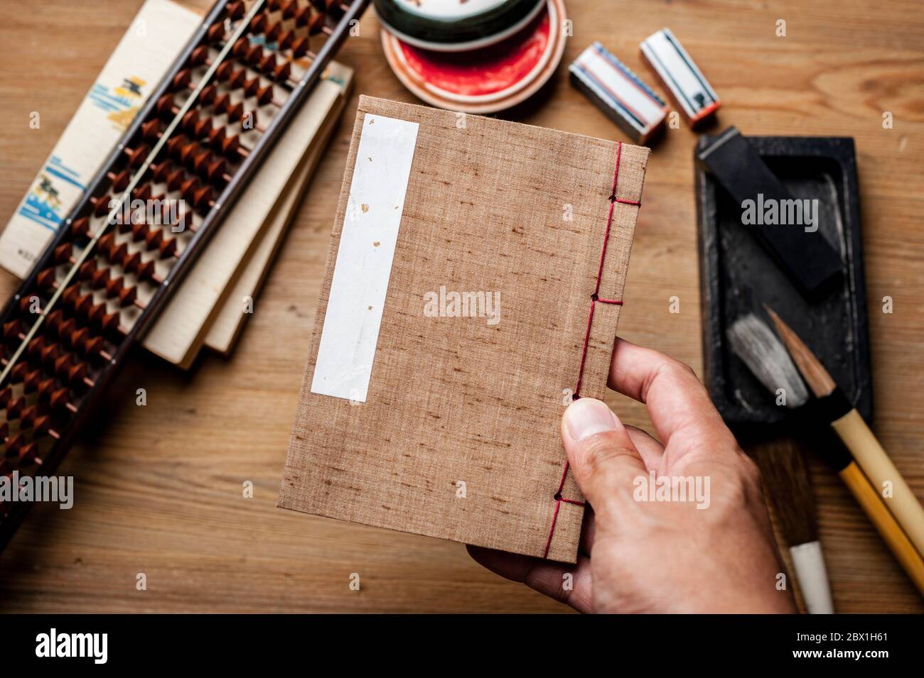 Closeup vintage style of Japanese stab binding in hand. Reading a book ...