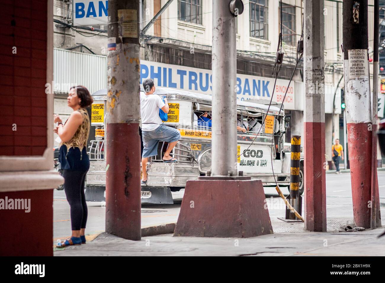 Traffic and pedestrians pass under the Filipino Chinese Friendship Arch ...