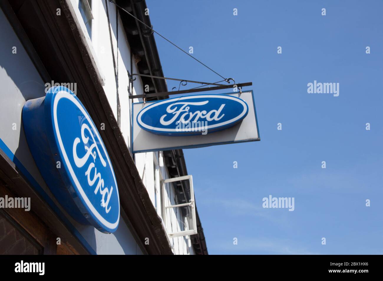 The Ford logo hanging from a car showroom in the UK Stock Photo - Alamy