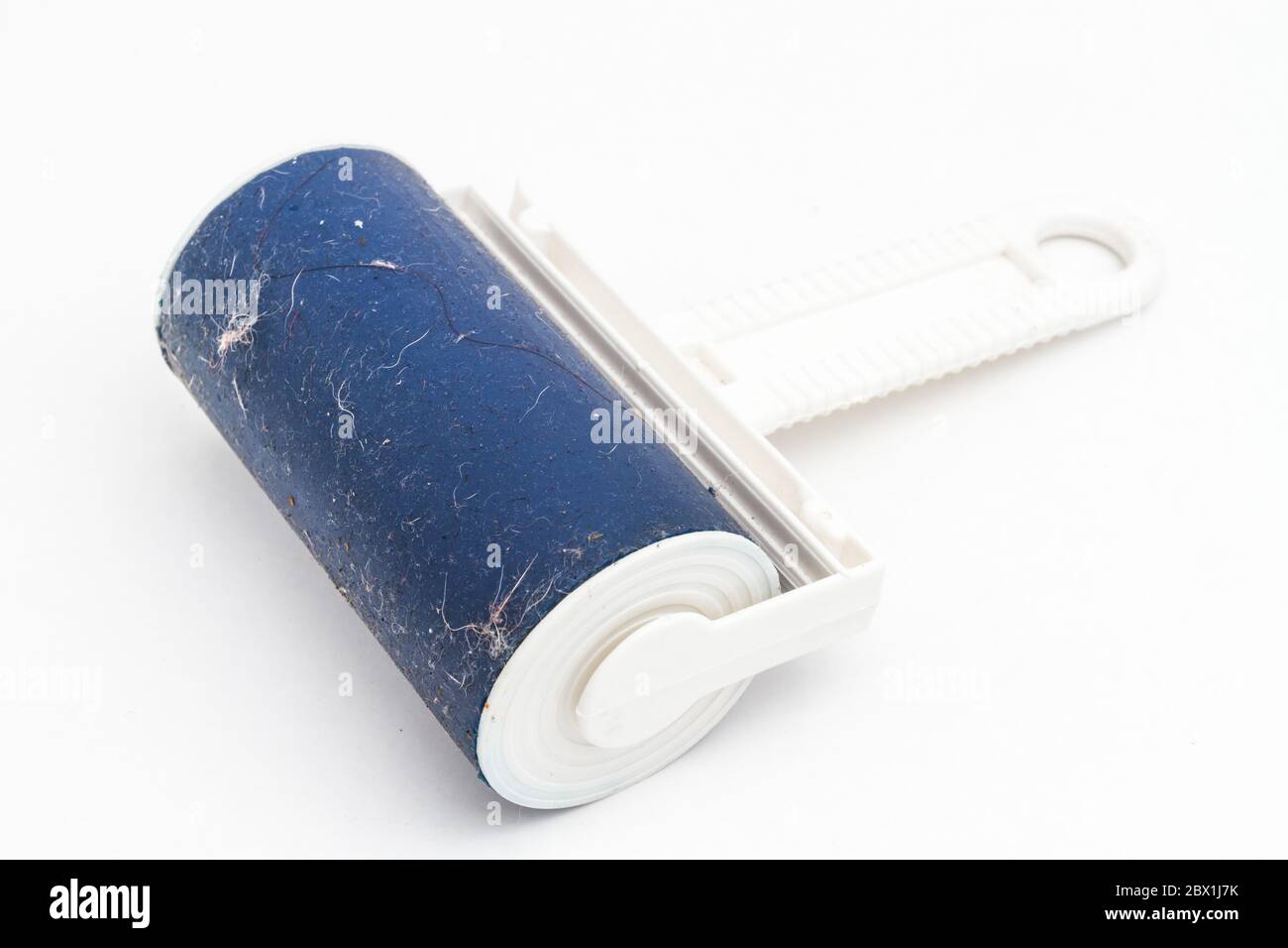 Blue sticky brush for cleaning clothes and furniture from dust on white ...