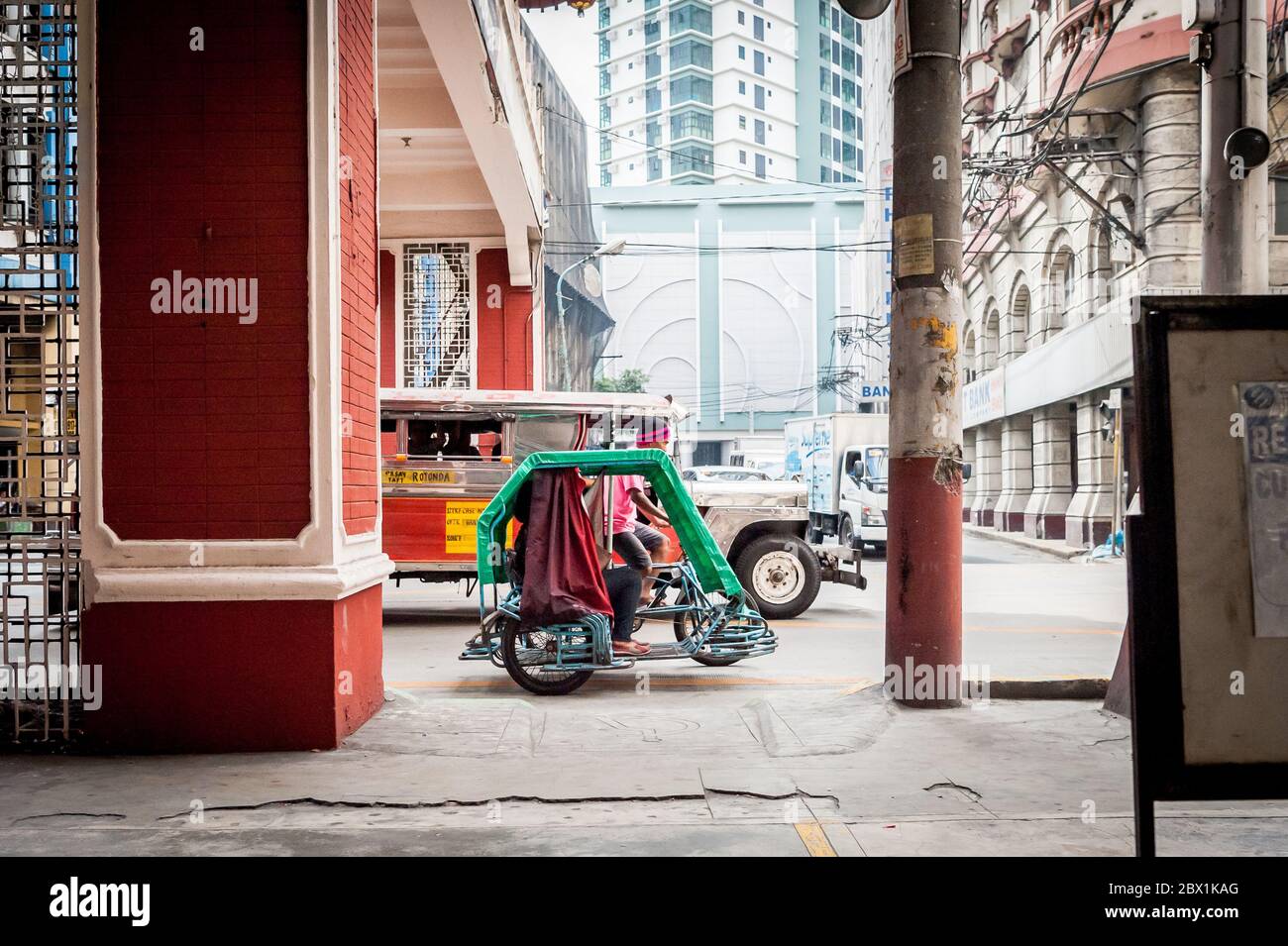 Traffic and pedestrians pass under the Filipino Chinese Friendship Arch ...